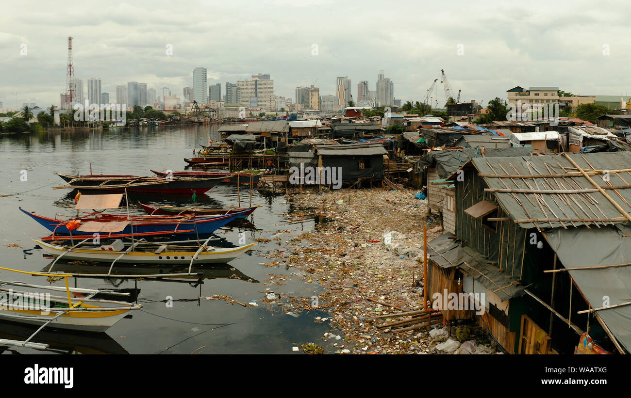 Manila cityscape with slums and dirty river on the background of ...