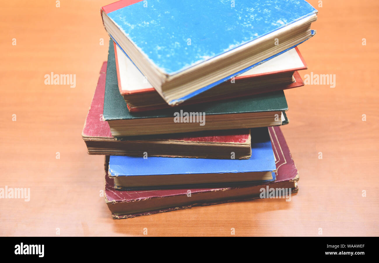 Old books on a wooden table / Open book stack in the library room for ...