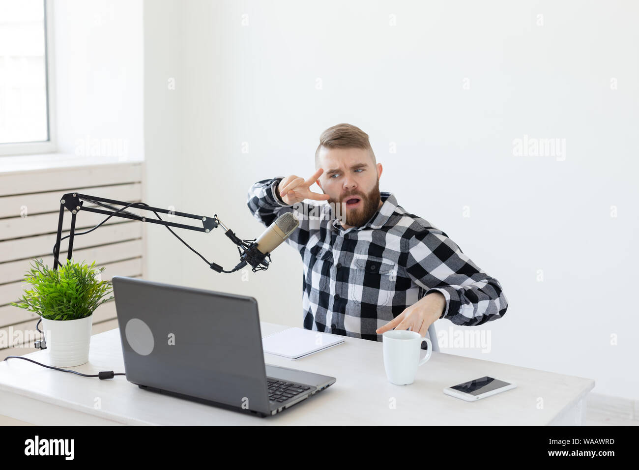Radio host concept - Handsome man working as radio host at radio ...