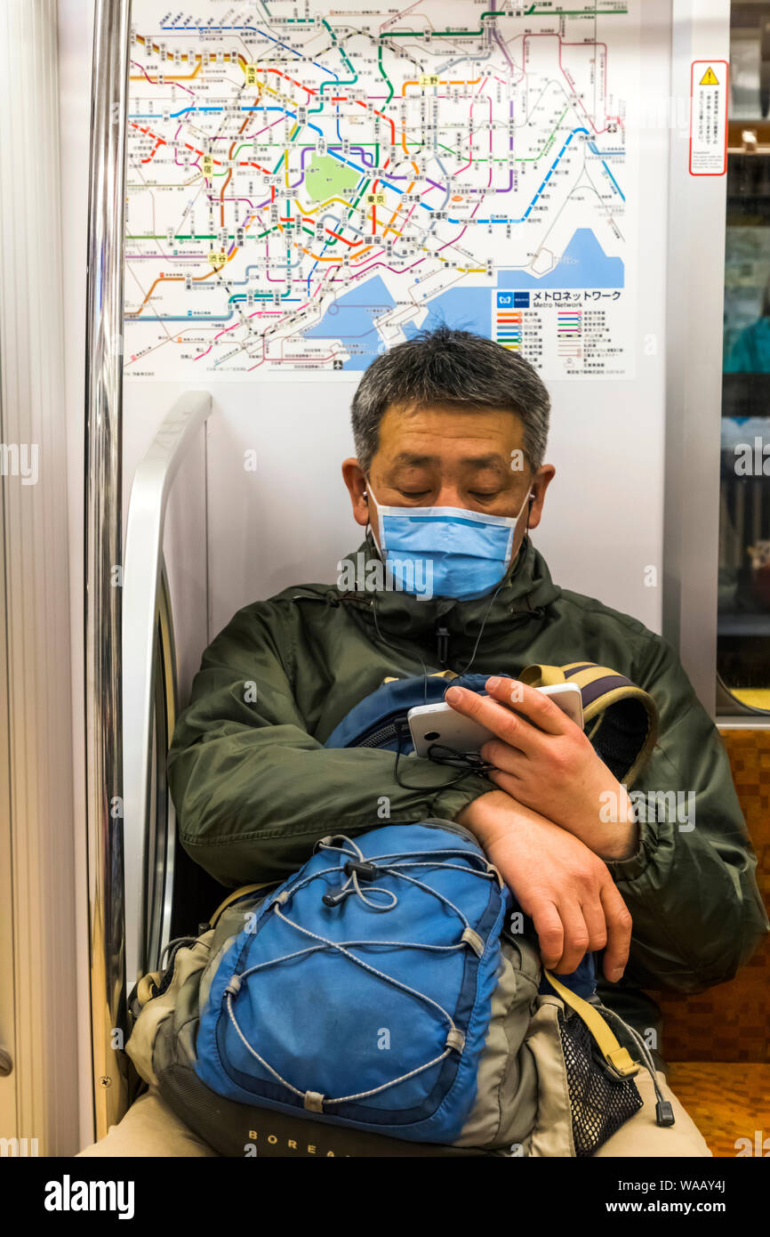 Japan, Honshu, Tokyo, Subway, Subway Passenger Wearing Allergy Mask and ...