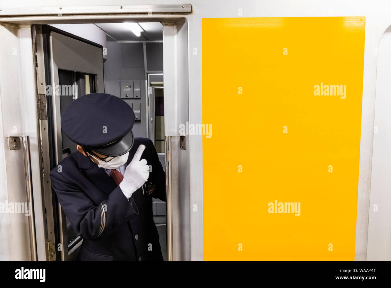 Japan, Honshu, Tokyo, Subway, Train Guard Wearing Allergy Mask ...