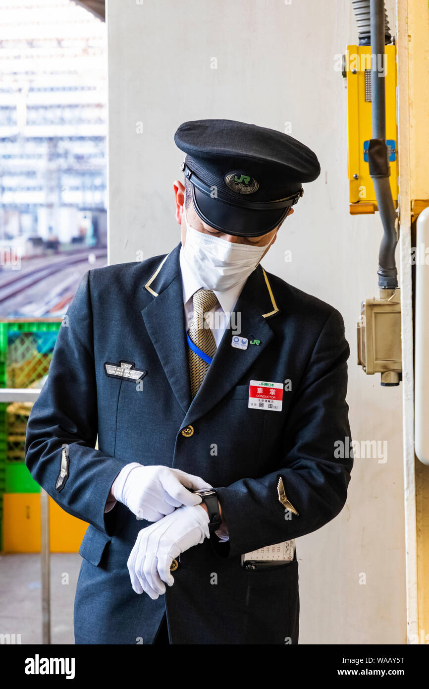 Japan, Honshu, Tokyo, Japan Railways (JR), Train Guard Checking Watch ...