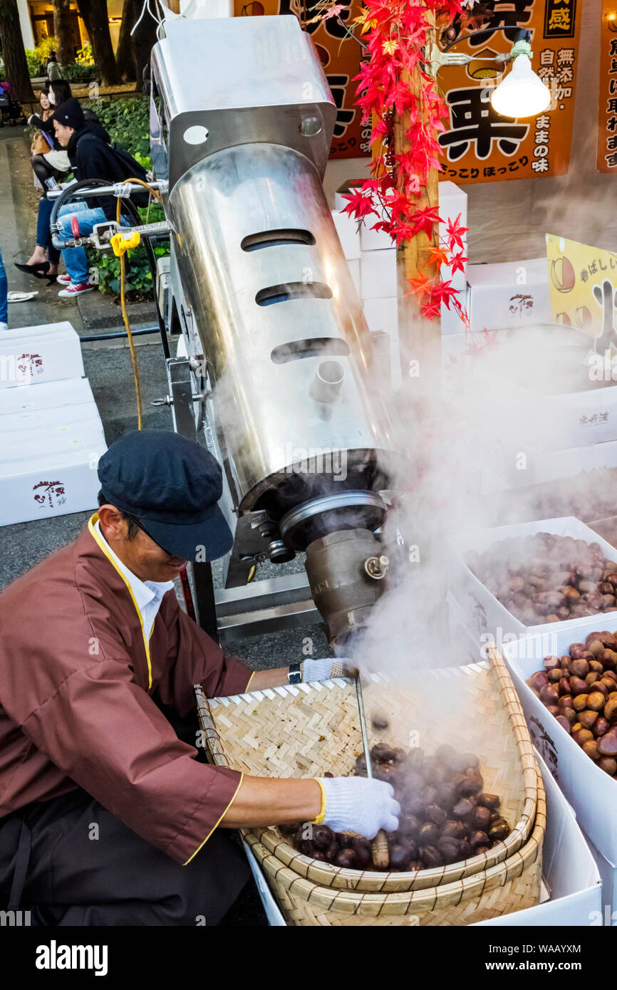 Japan, Honshu, Tokyo, Hibiya Park, Food Festival, Man Making Roasted ...