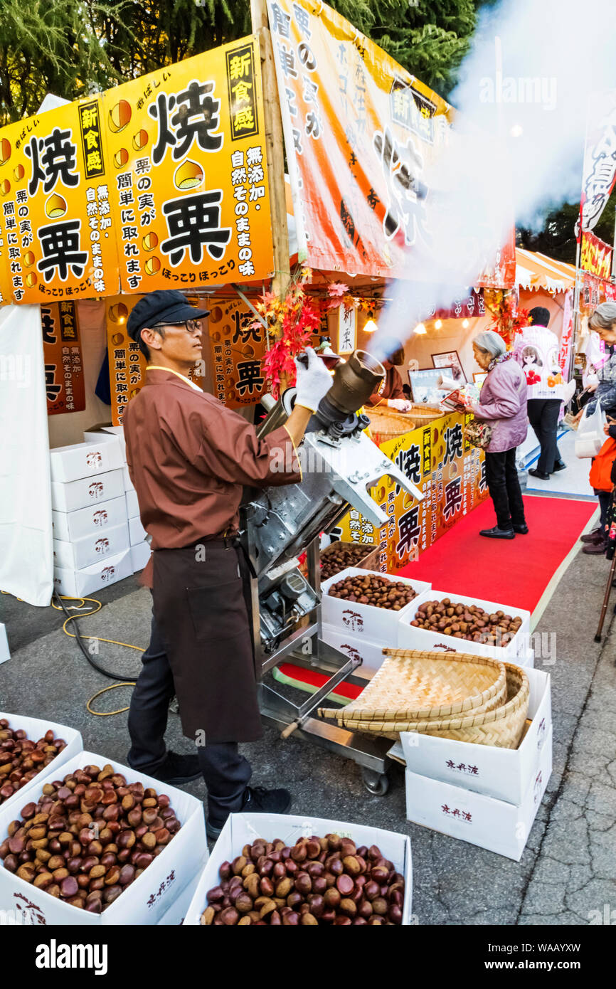 Japan, Honshu, Tokyo, Hibiya Park, Food Festival, Man Making Roasted ...