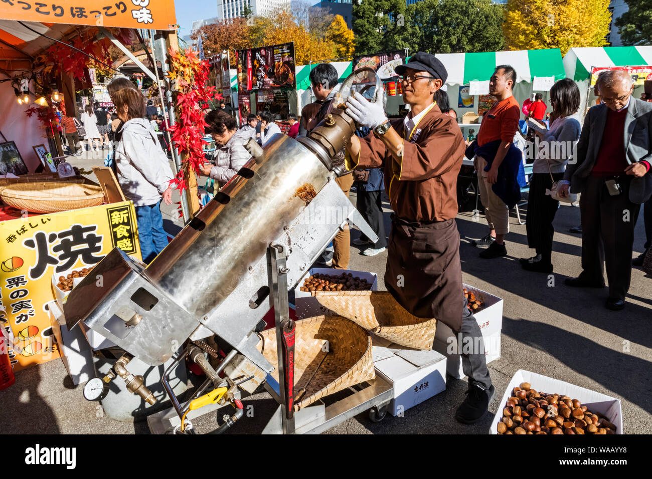 Japan, Honshu, Tokyo, Hibiya Park, Food Festival, Man Making Roasted ...