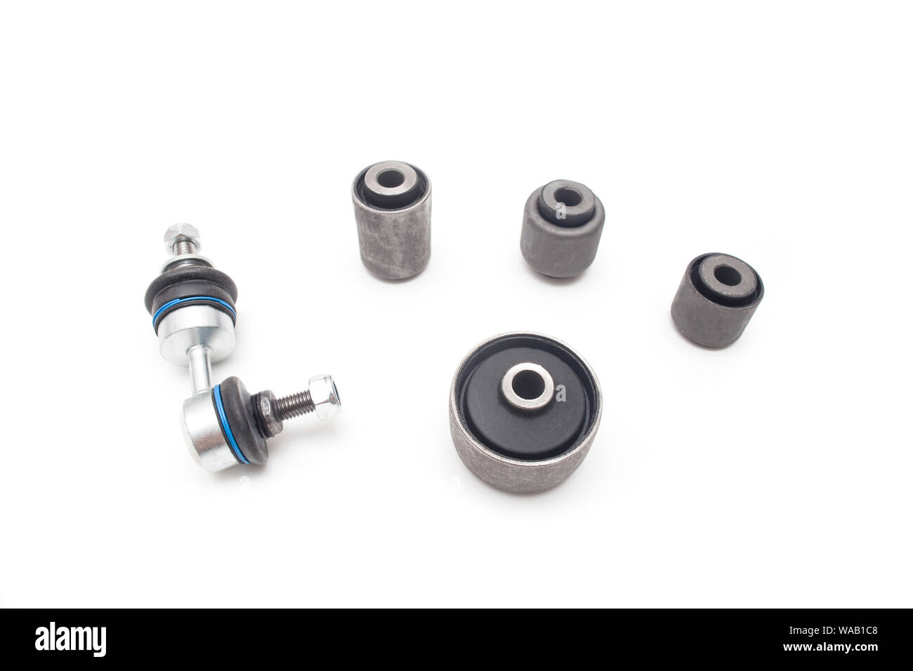 Set of silent blocks and stabilizer rod for car suspension on a white ...