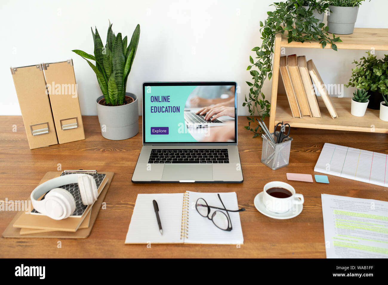 Group of office supplies and objects on the desk in front of laptop ...