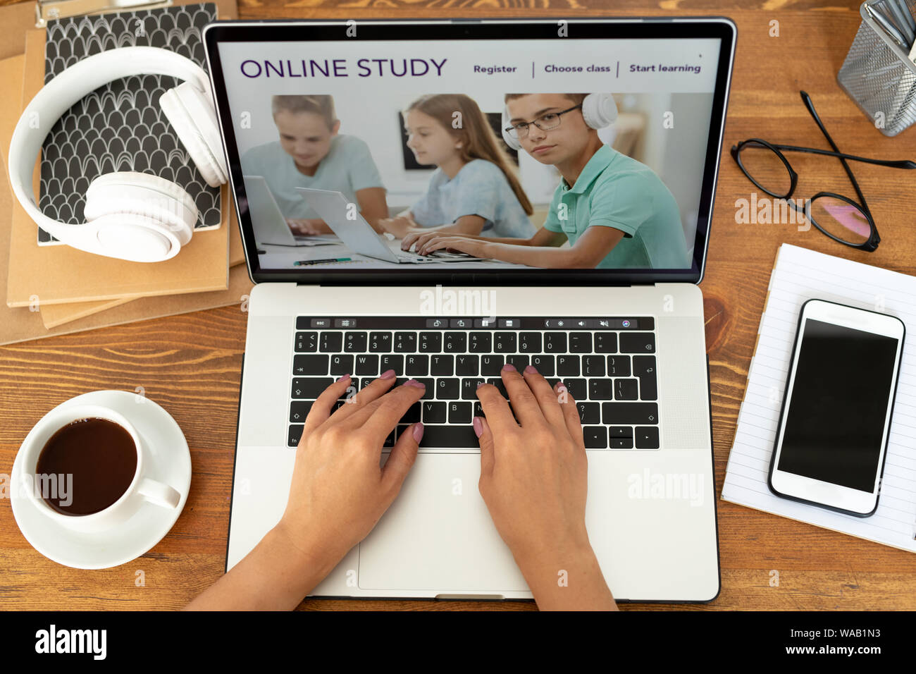 Top view of young adult hands typing on laptop keypad Stock Photo - Alamy