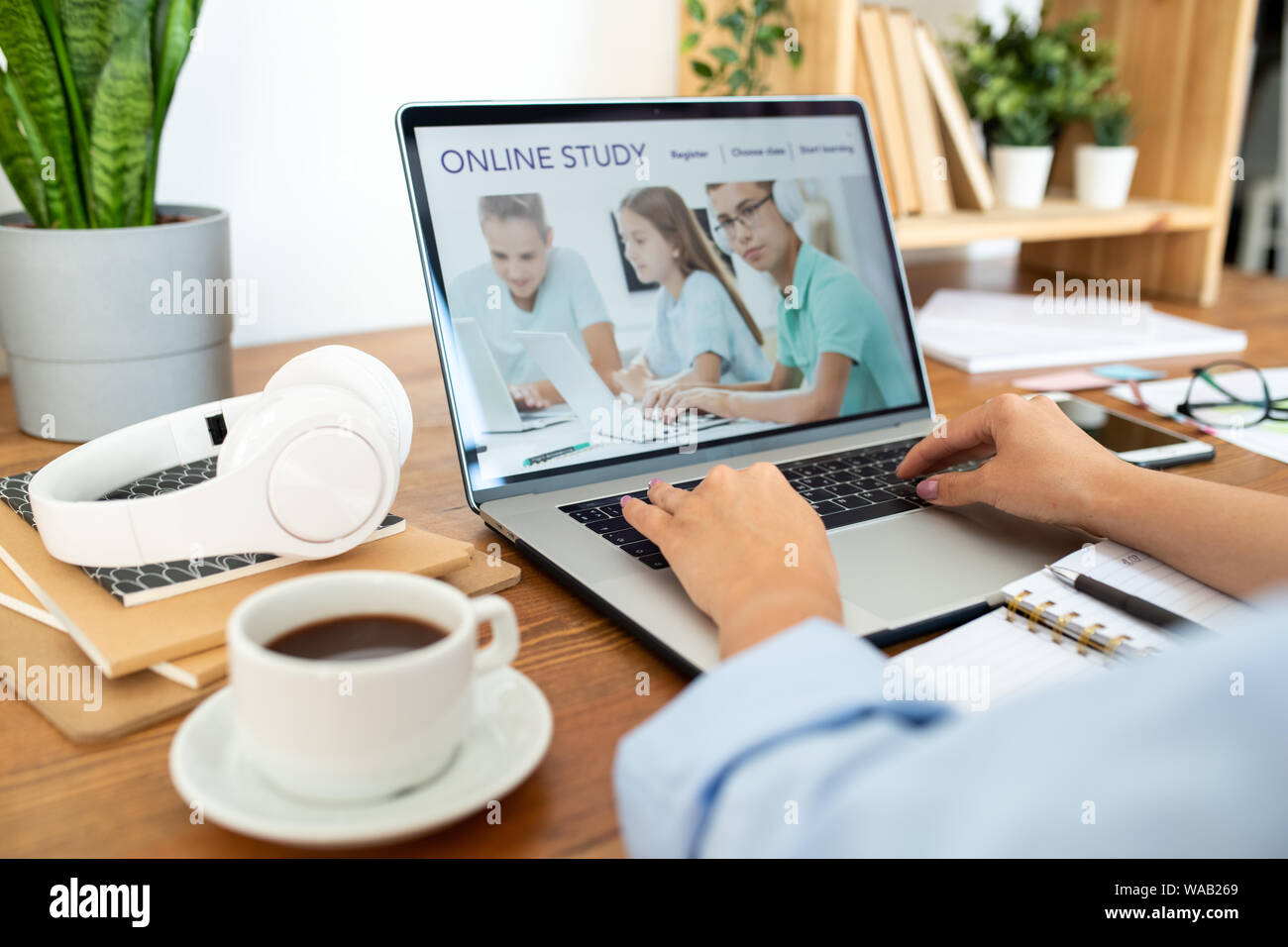 Female hands pressing keys of laptop keypad while sitting in front of ...