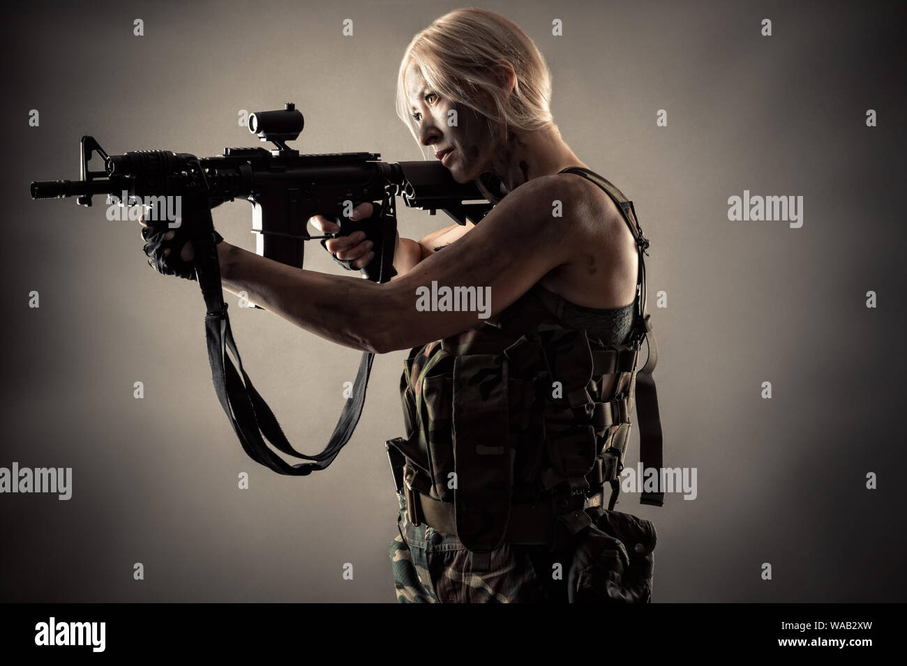 young blond woman with gun Stock Photo - Alamy