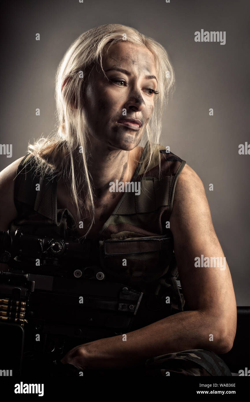 portrait pensive woman with machine gun in hands Stock Photo - Alamy