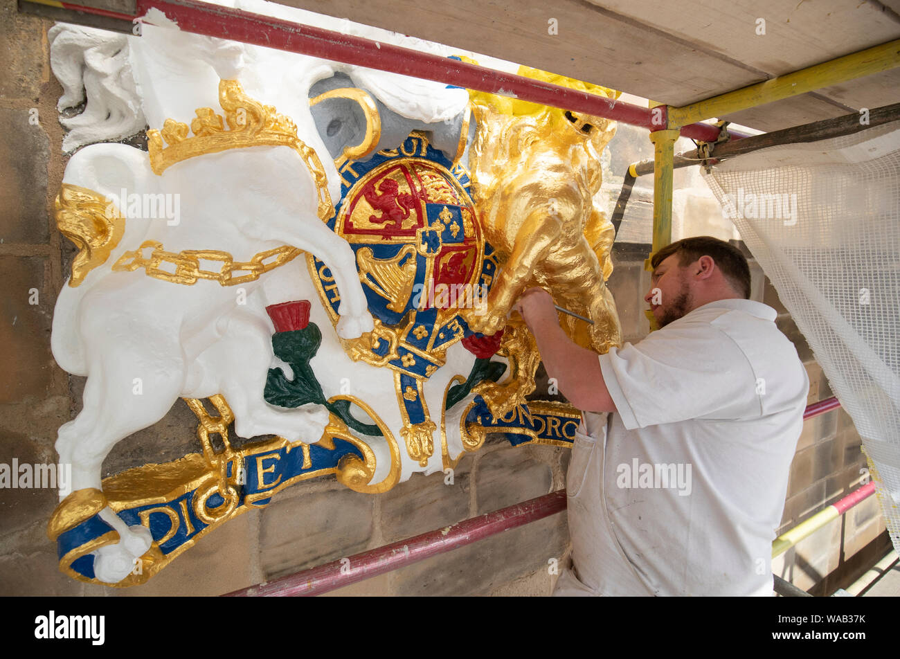 Colin Morris, from Nevin of Edinburgh Painters, applies gold leaf to ...