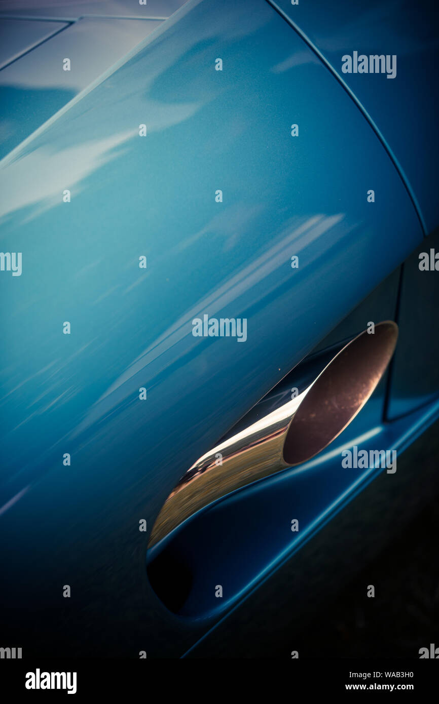 Close up vertical shot of a blue car exhaust pipe Stock Photo - Alamy