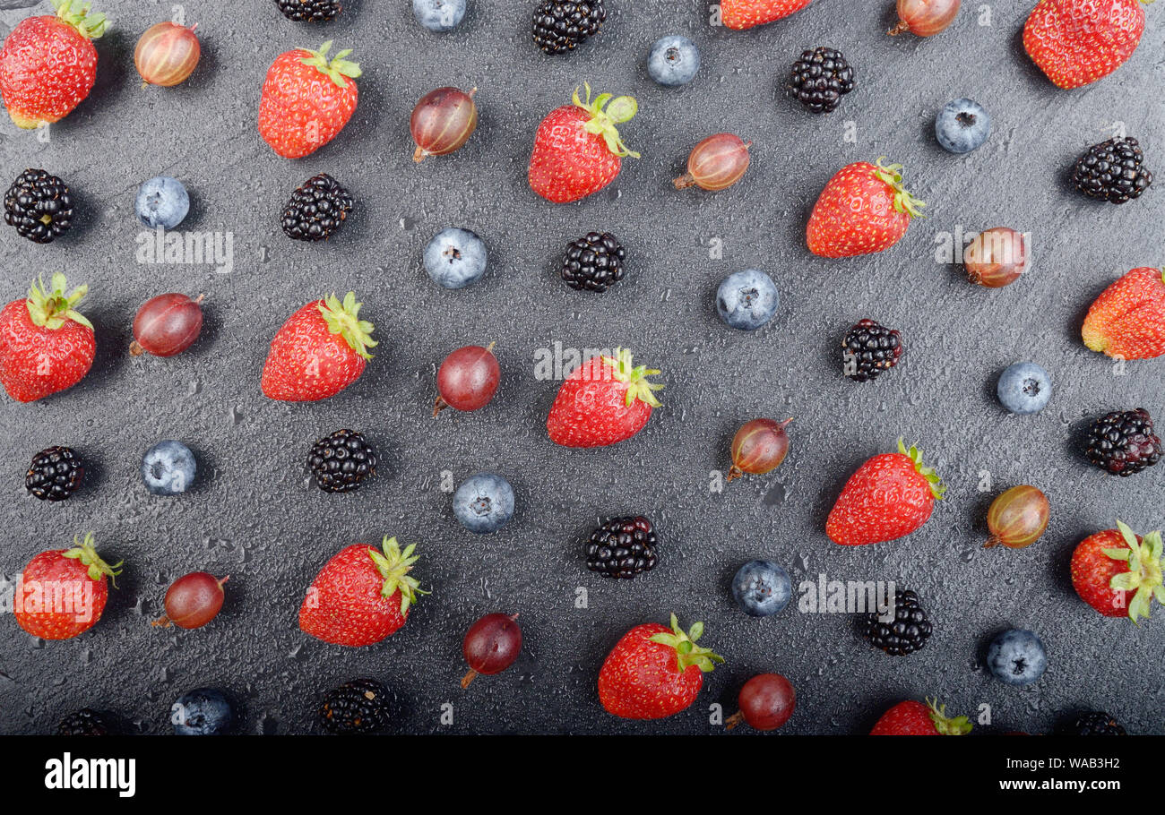 Flat lay view at ripe bilberry strawberry raspberry blackberry and ...
