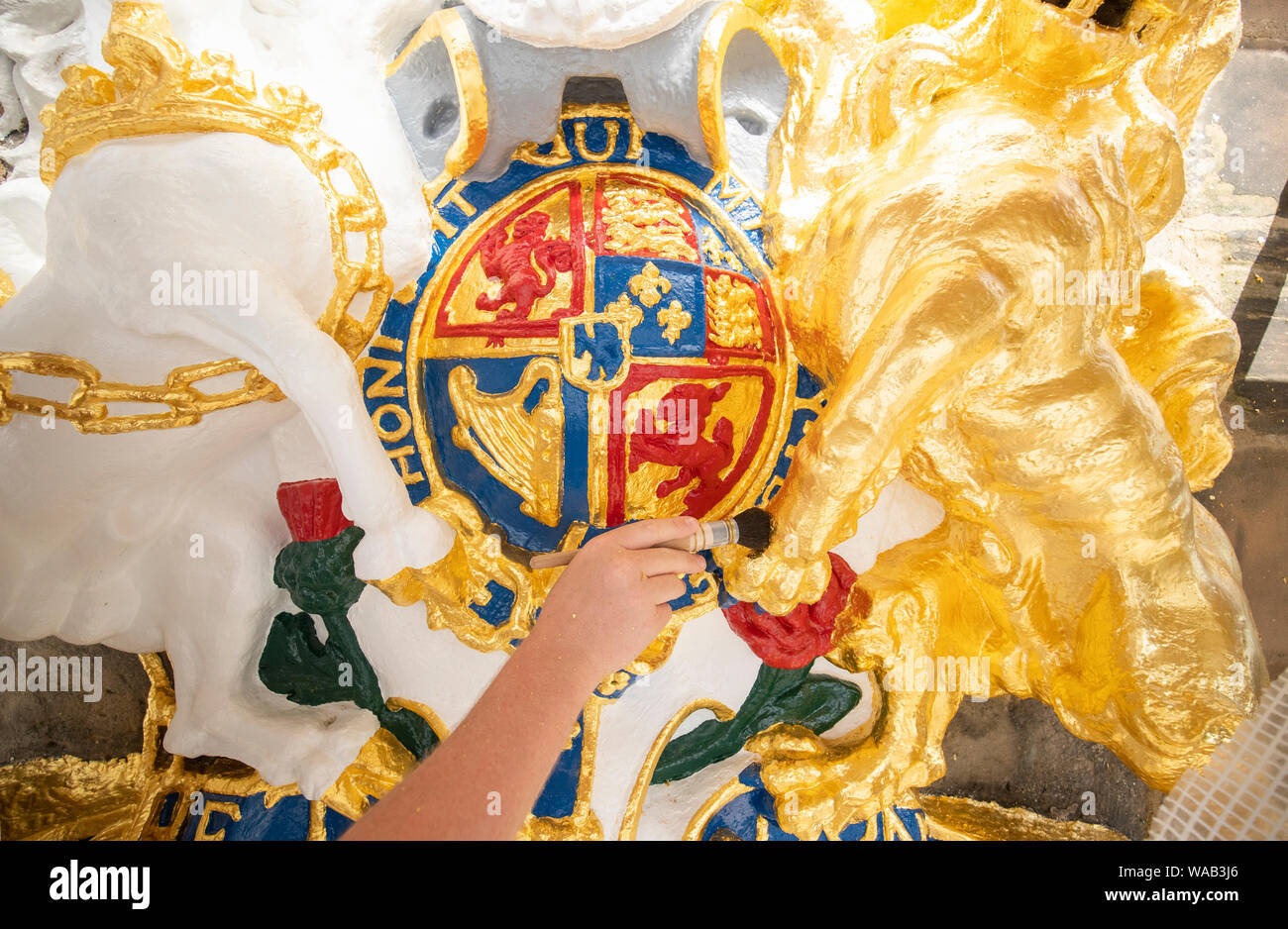 Colin Morris, from Nevin of Edinburgh Painters, applies gold leaf to ...