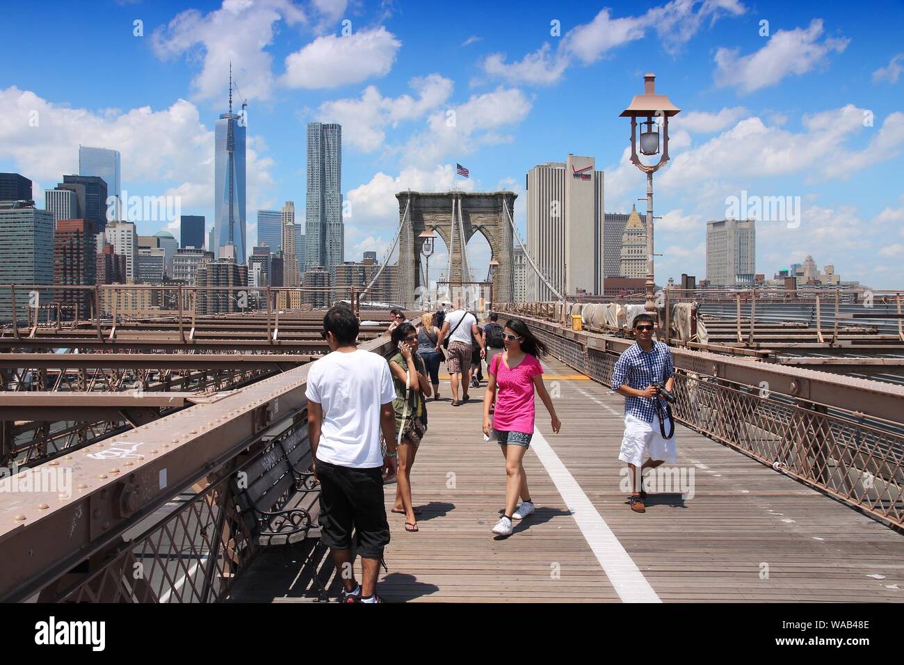 NEW YORK, USA - JULY 5, 2013: People walk along famous Brooklyn Bridge ...