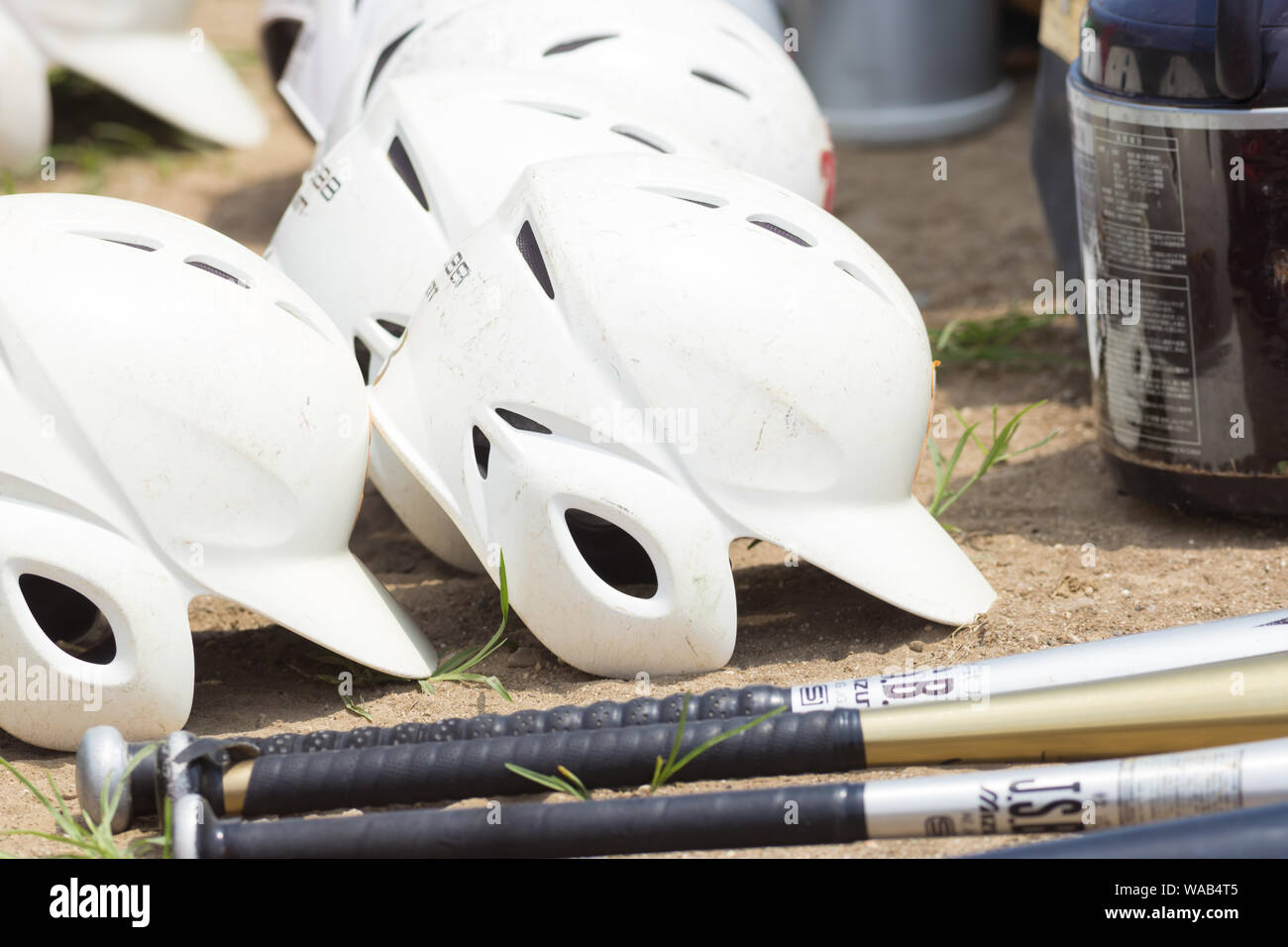helmets aligned on side of baseball field Stock Photo - Alamy