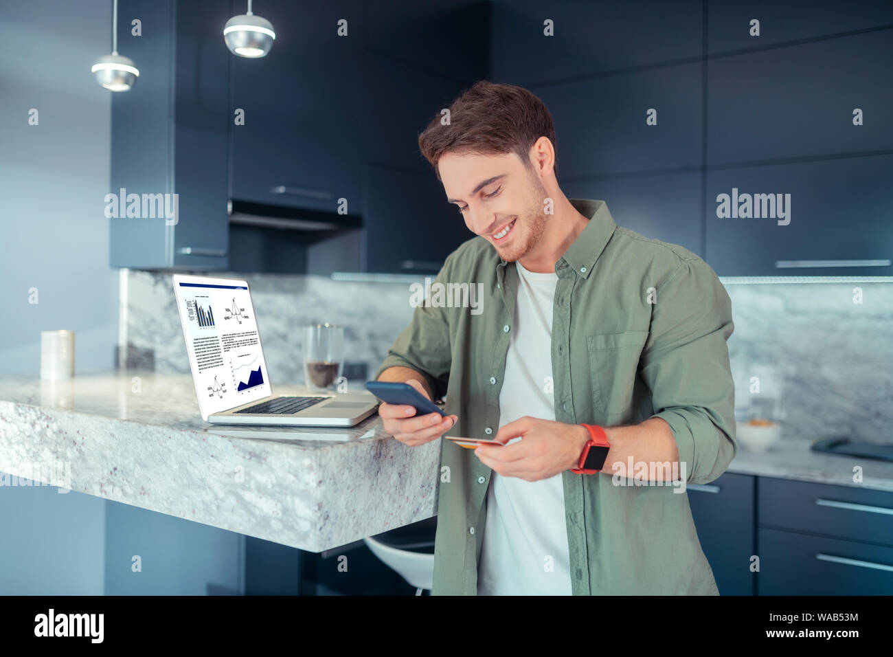 Man processing online payment while shopping online Stock Photo - Alamy