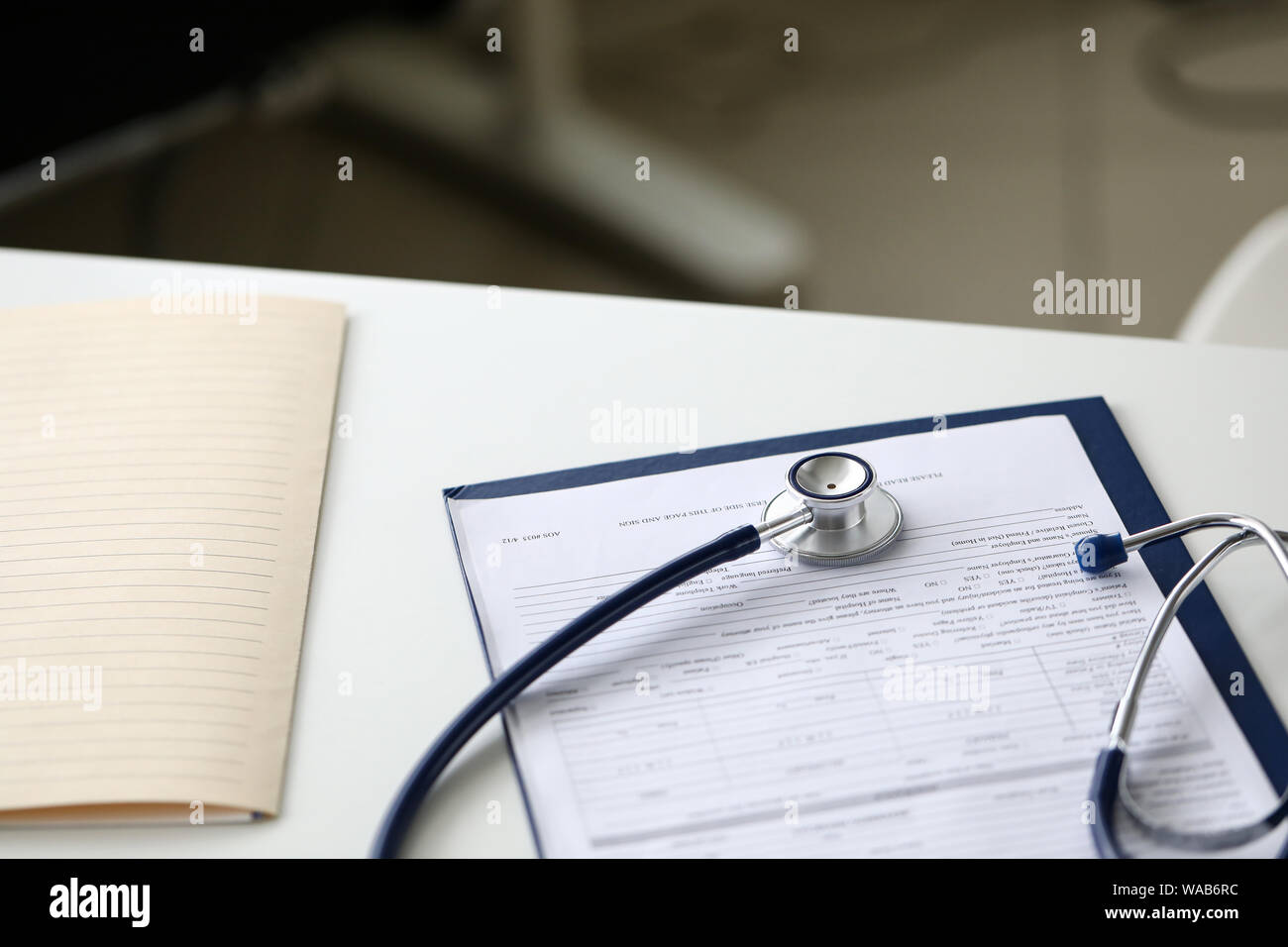 Stethoscope head lying on medical paper document Stock Photo - Alamy