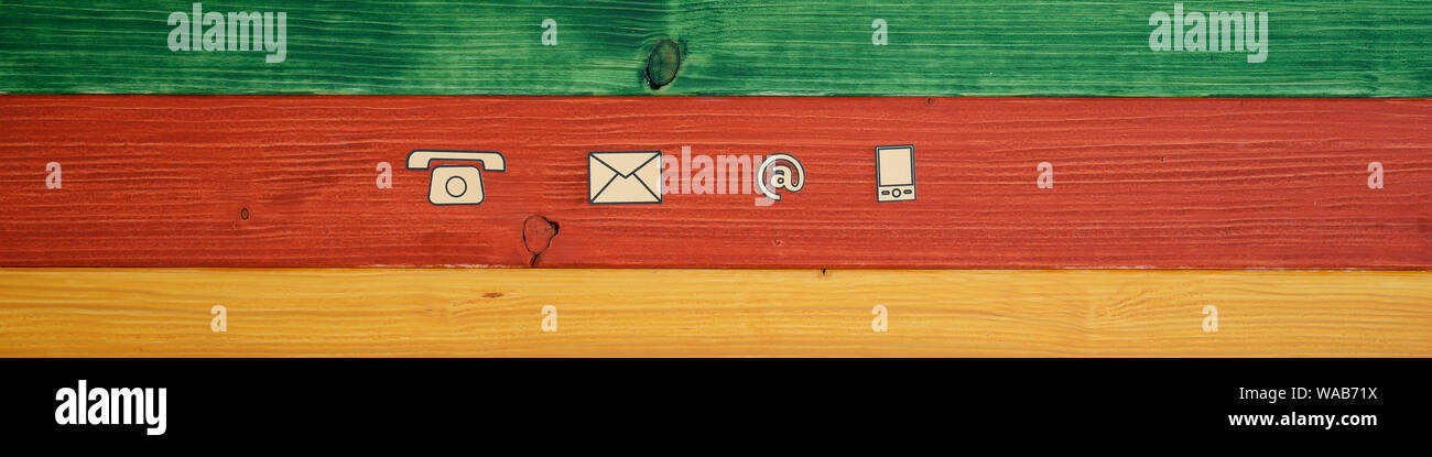 Wide view image of contact and communication icons cut out of paper ...