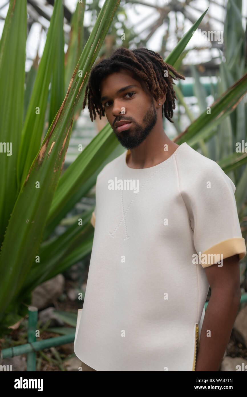 Young model promoting clothing posing in greenhouse Stock Photo - Alamy