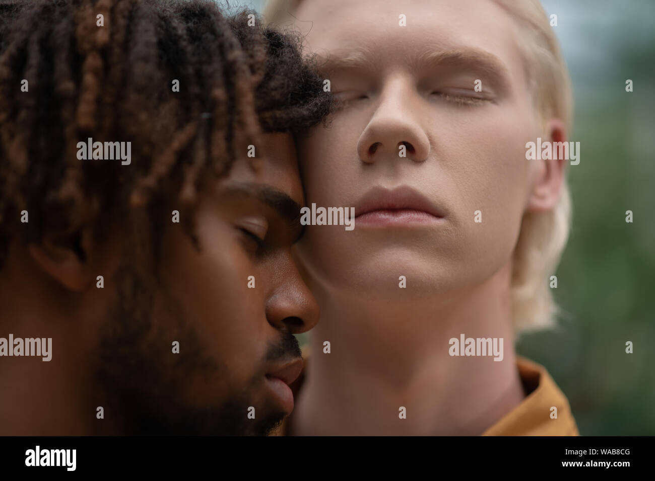 Handsome men with different skin color closing eyes Stock Photo - Alamy