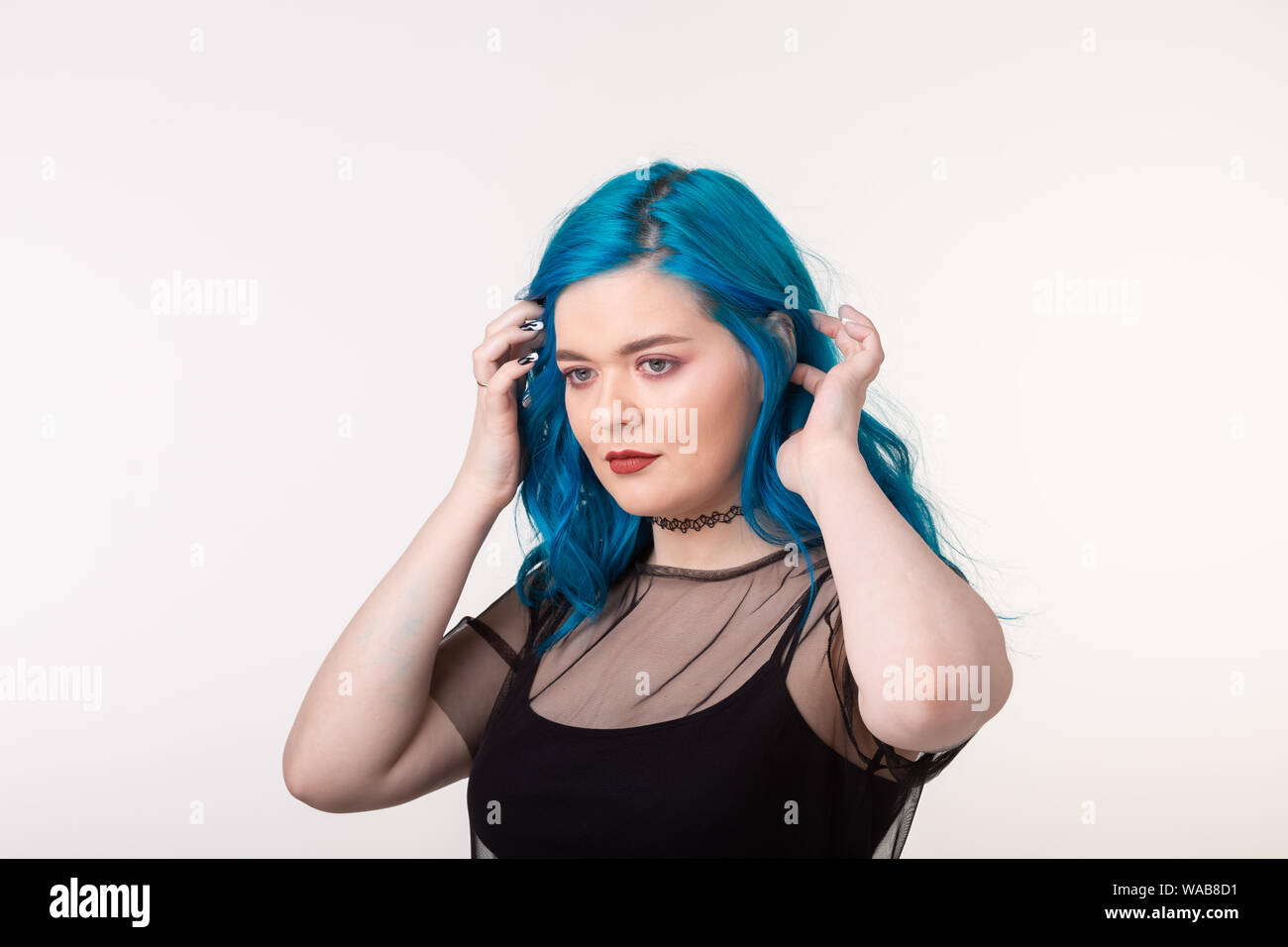 People and fashion concept - Beautiful woman with blue hair posing over ...