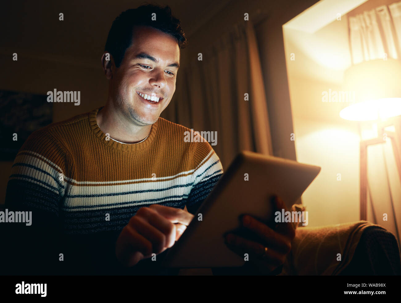 Close-up of a man using digital tablet till late at night in home Stock ...