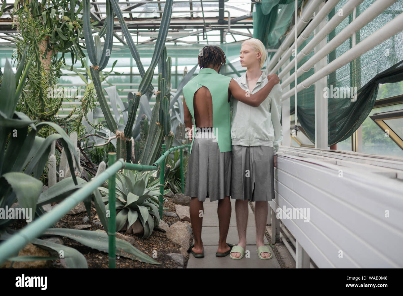 Dark-skinned man touching shoulder of handsome blonde man Stock Photo ...