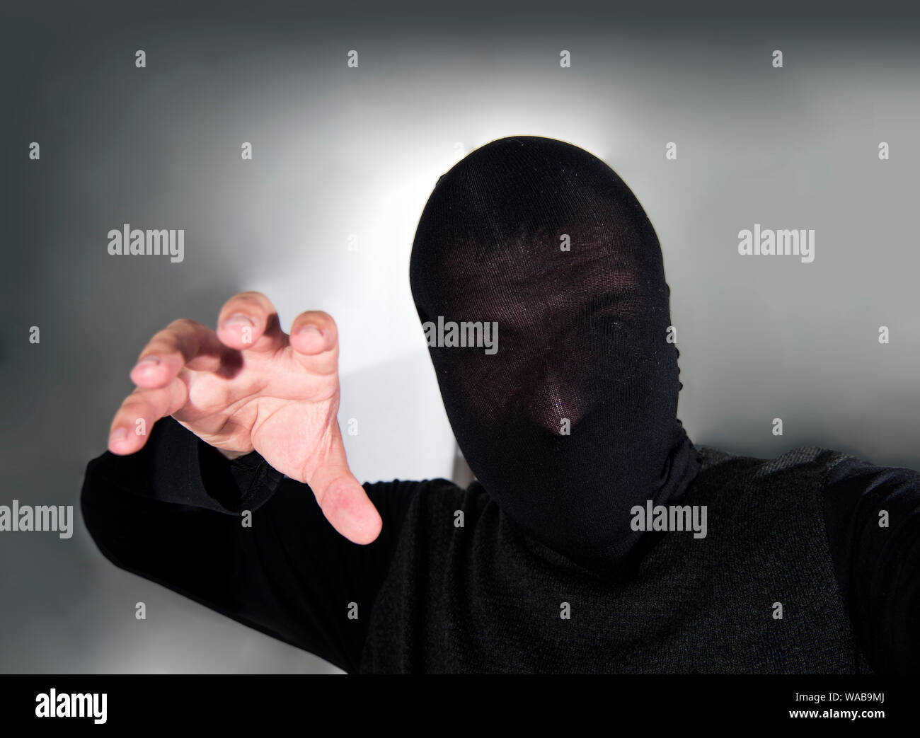 Burglar in mask robbing hi-res stock photography and images - Alamy
