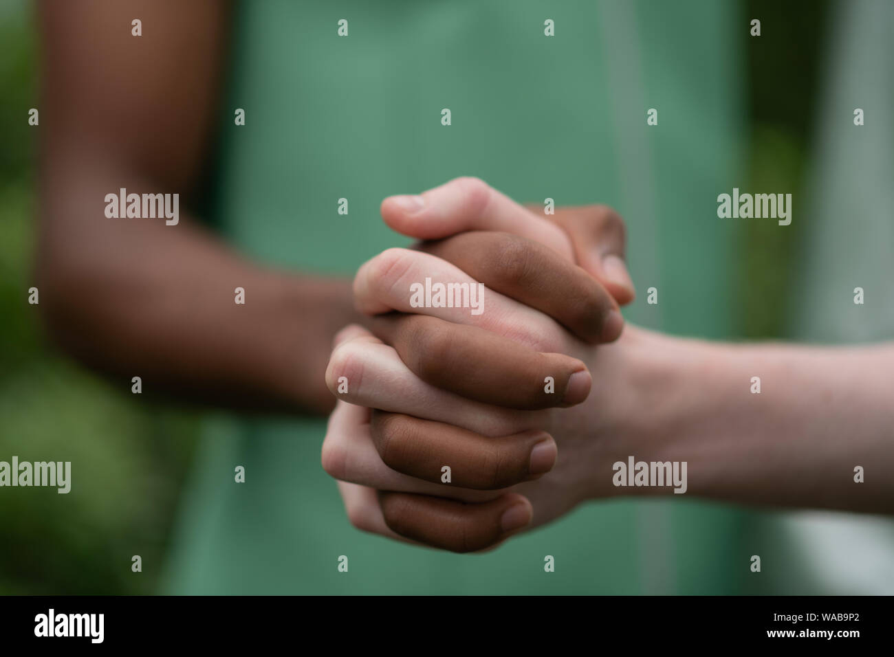 Men with different skin color holding hands together Stock Photo - Alamy