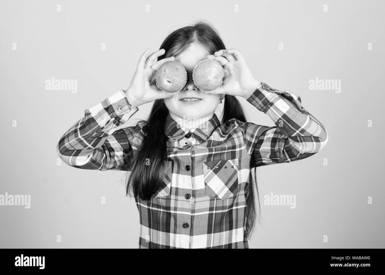 The cupcake, a miniature treat. Funny little girl covering eyes with ...