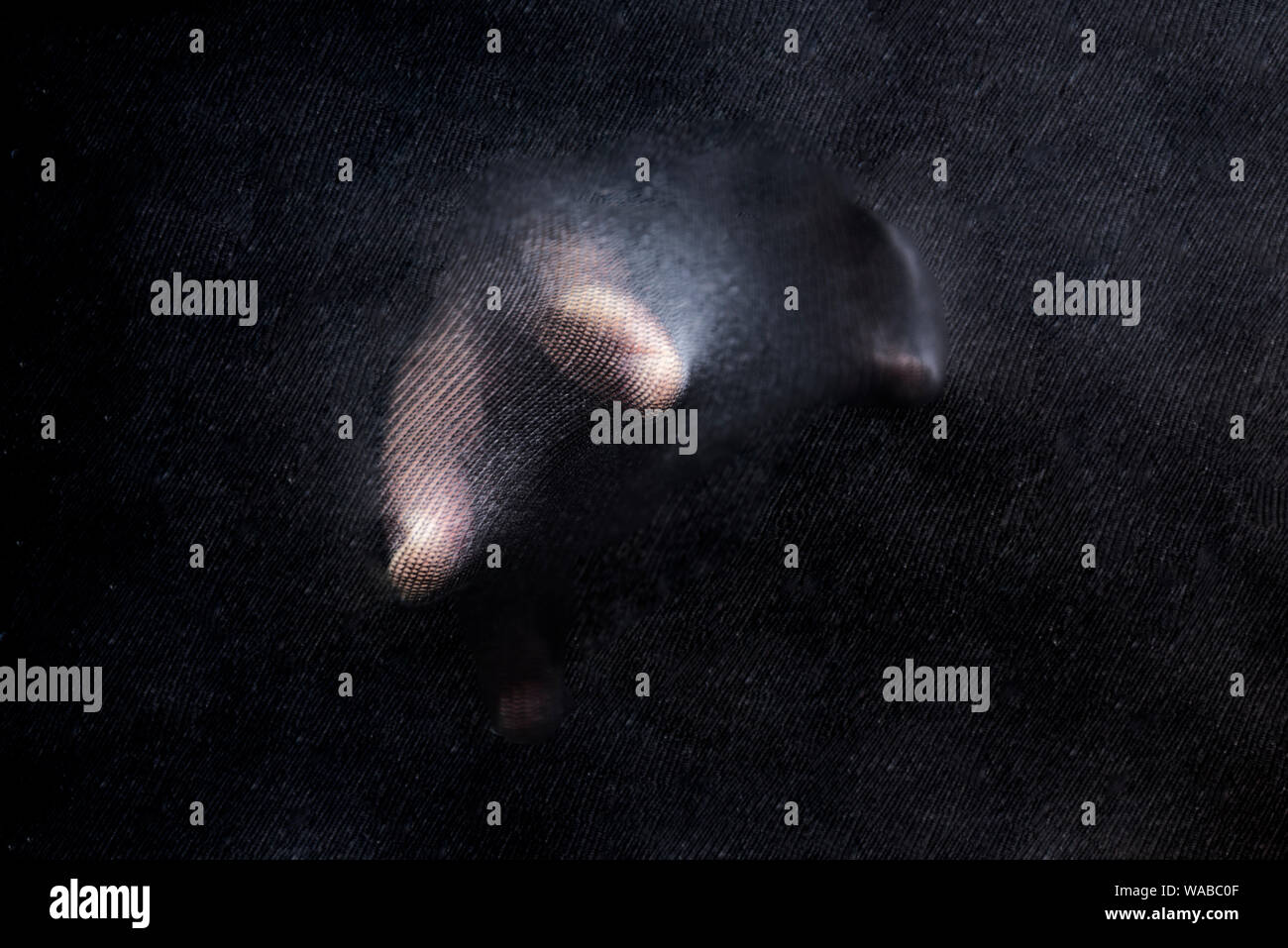 Man hand in black textured background. Abstract photo Stock Photo - Alamy