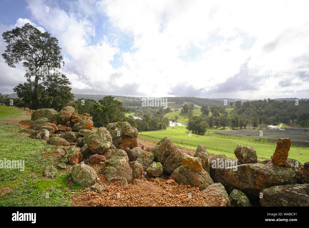 Countryside farm land landscape view with stones at the foreground ...