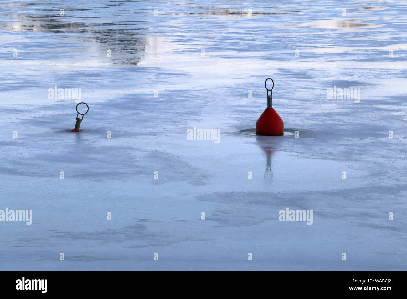 Two red buoys on top of the surface of the frozen Baltic Sea in Espoo ...