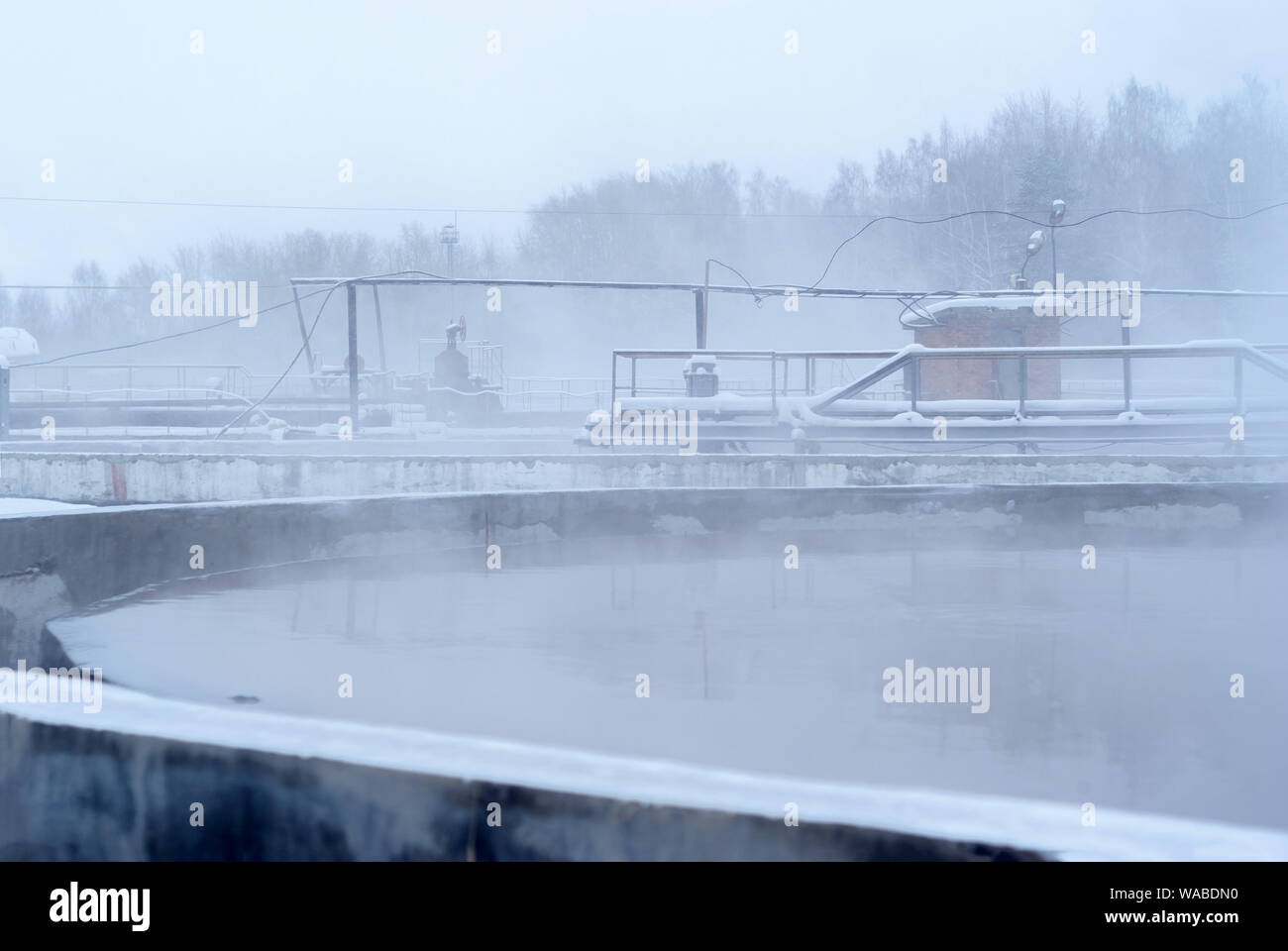 sewage treatment plant in winter, icy primary settling tanks Stock ...
