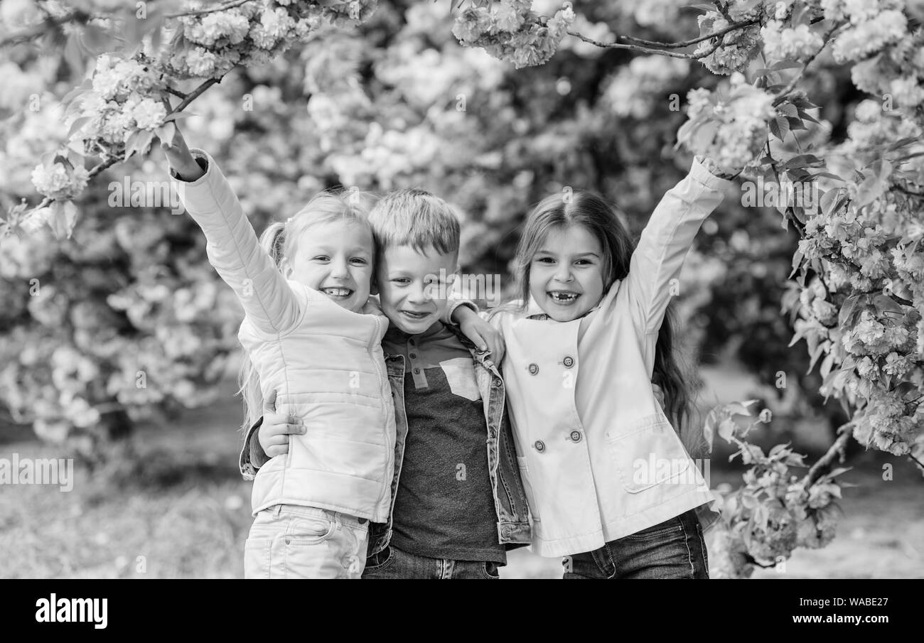 Happy spring vacation. Children enjoy warm spring. Lost in blossom ...