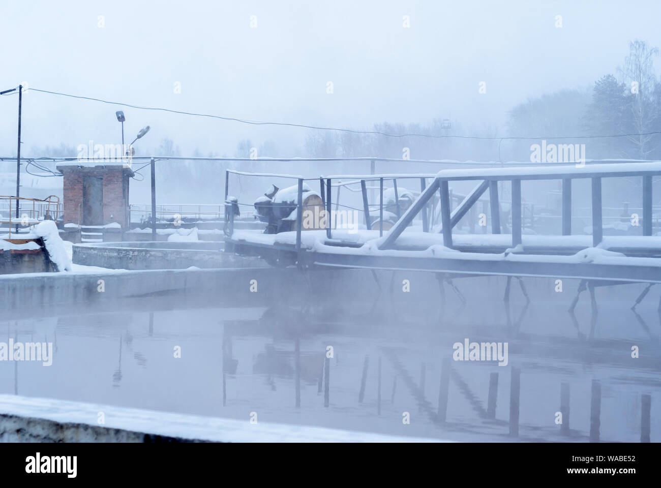 sewage treatment plant in winter, icy primary settling tanks Stock ...