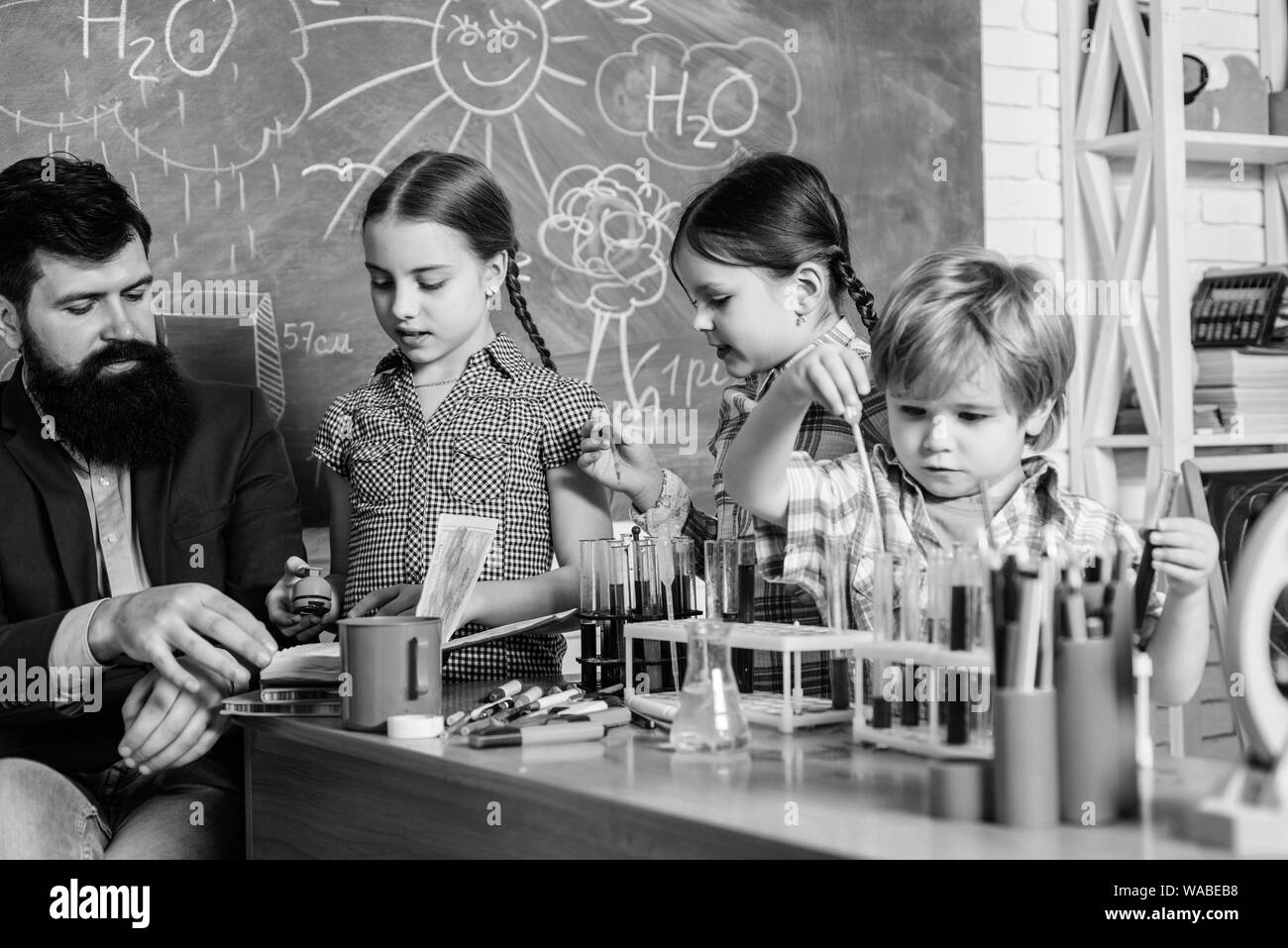students doing science experiments with microscope in lab. school kids ...