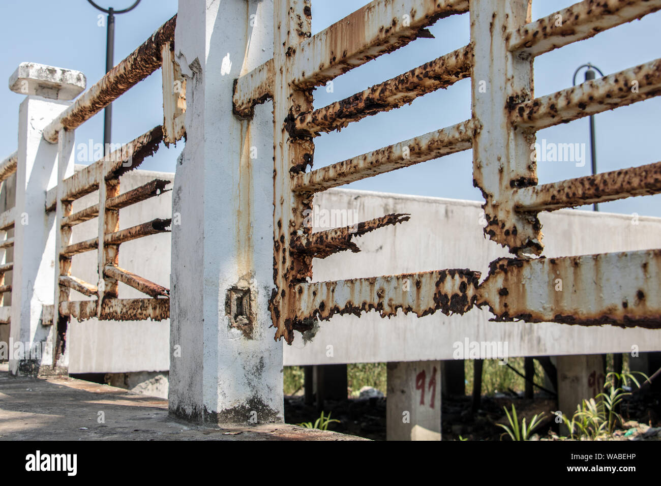 Rusting railing at the pier. Corrosion on white railing, close up view ...
