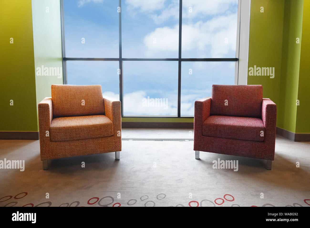 Two soft chairs in a large panoramic window. View of the sky and clouds ...