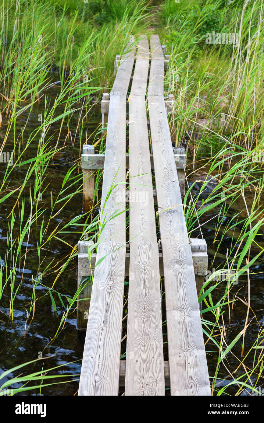 Wooden footbridge over the water Stock Photo - Alamy