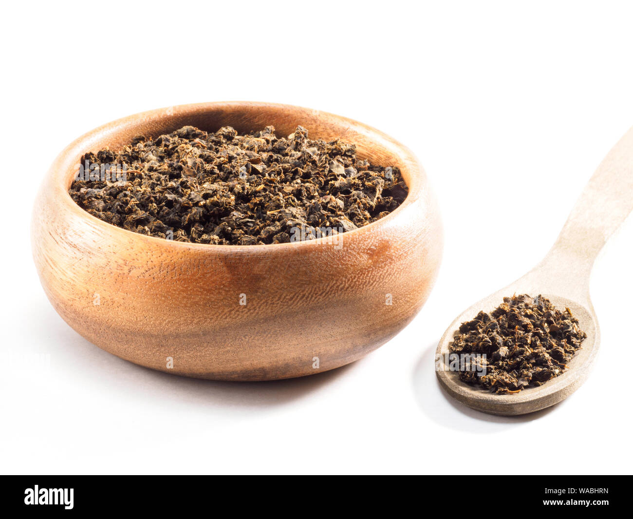 Fermented granular tea from Cherry (Cerasus) leaves in wooden cup with ...