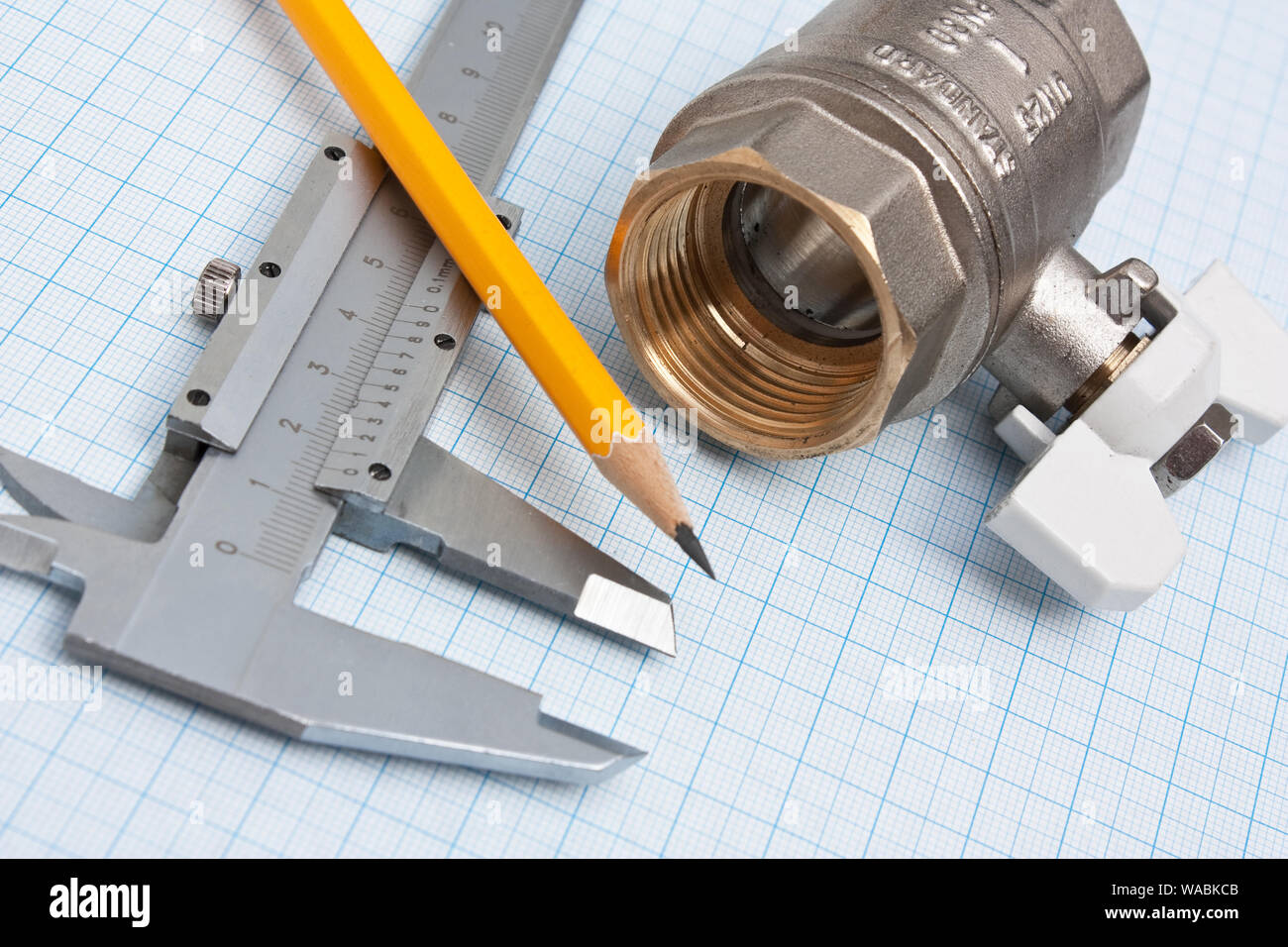 water inlet valve on a background of graph paper Stock Photo - Alamy
