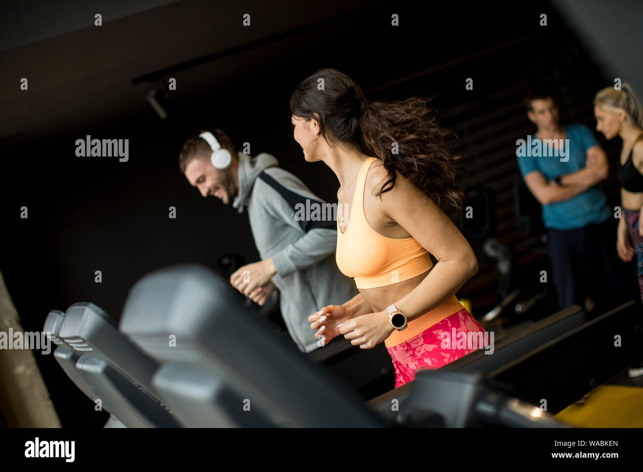 Group of young people using threadmill in modern gym Stock Photo - Alamy