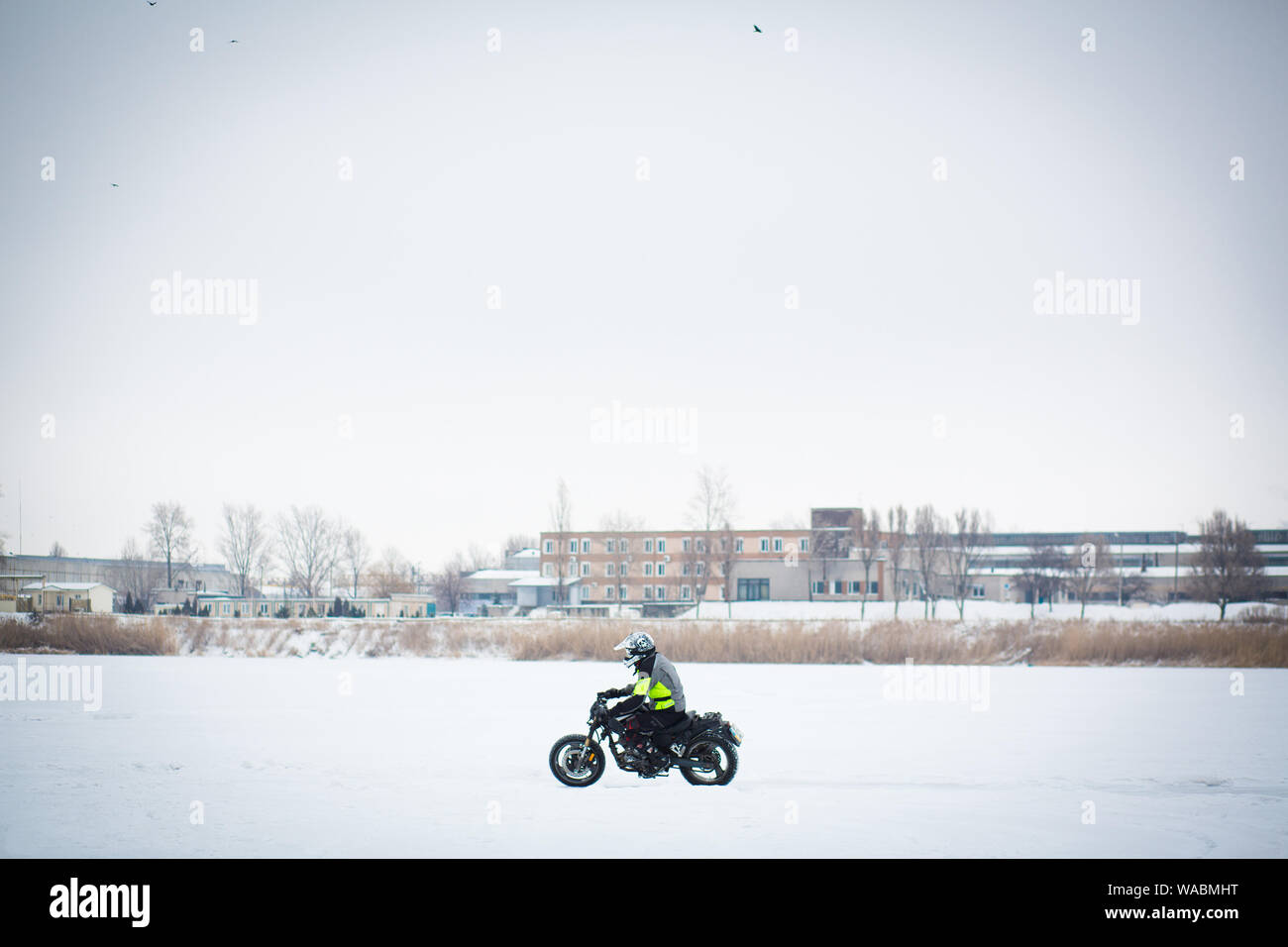 A guy rides a motorcycle on a frozen lake Stock Photo - Alamy