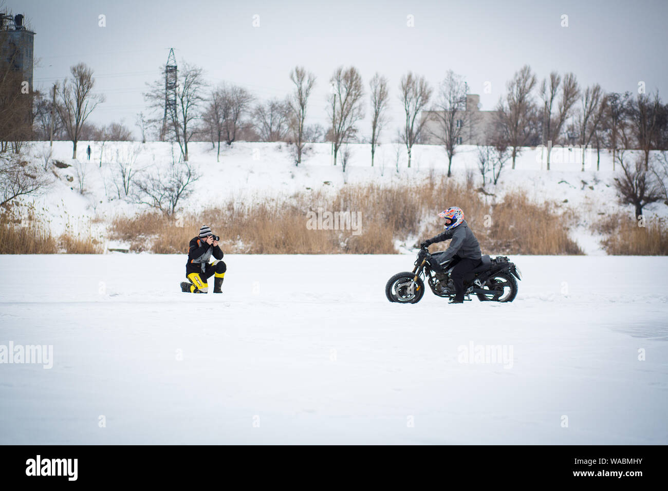 A guy rides a motorcycle on a frozen lake Stock Photo - Alamy