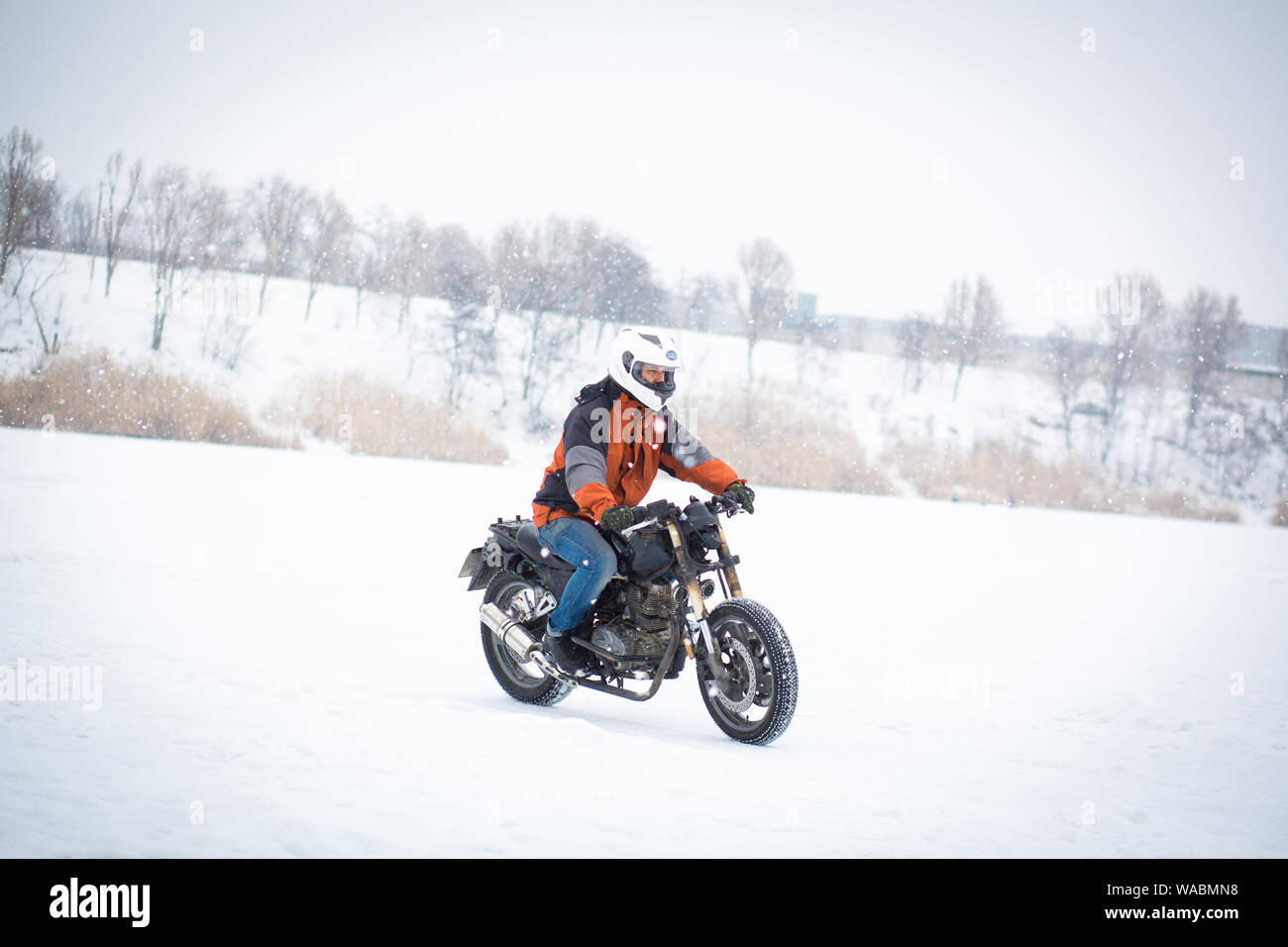 A guy rides a motorcycle on a frozen lake Stock Photo - Alamy
