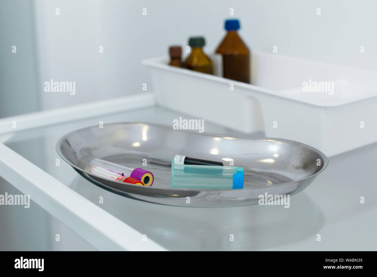 On a metal tray is a set for blood sampling for tests. test tube ...