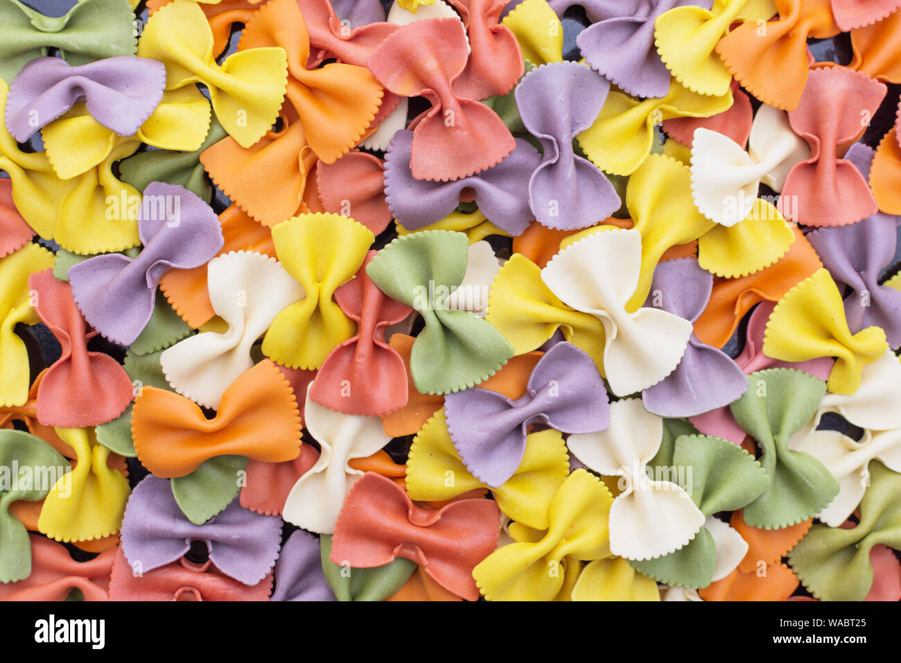 Italian raw multicolored farfalle pasta close-up, texture effect ...